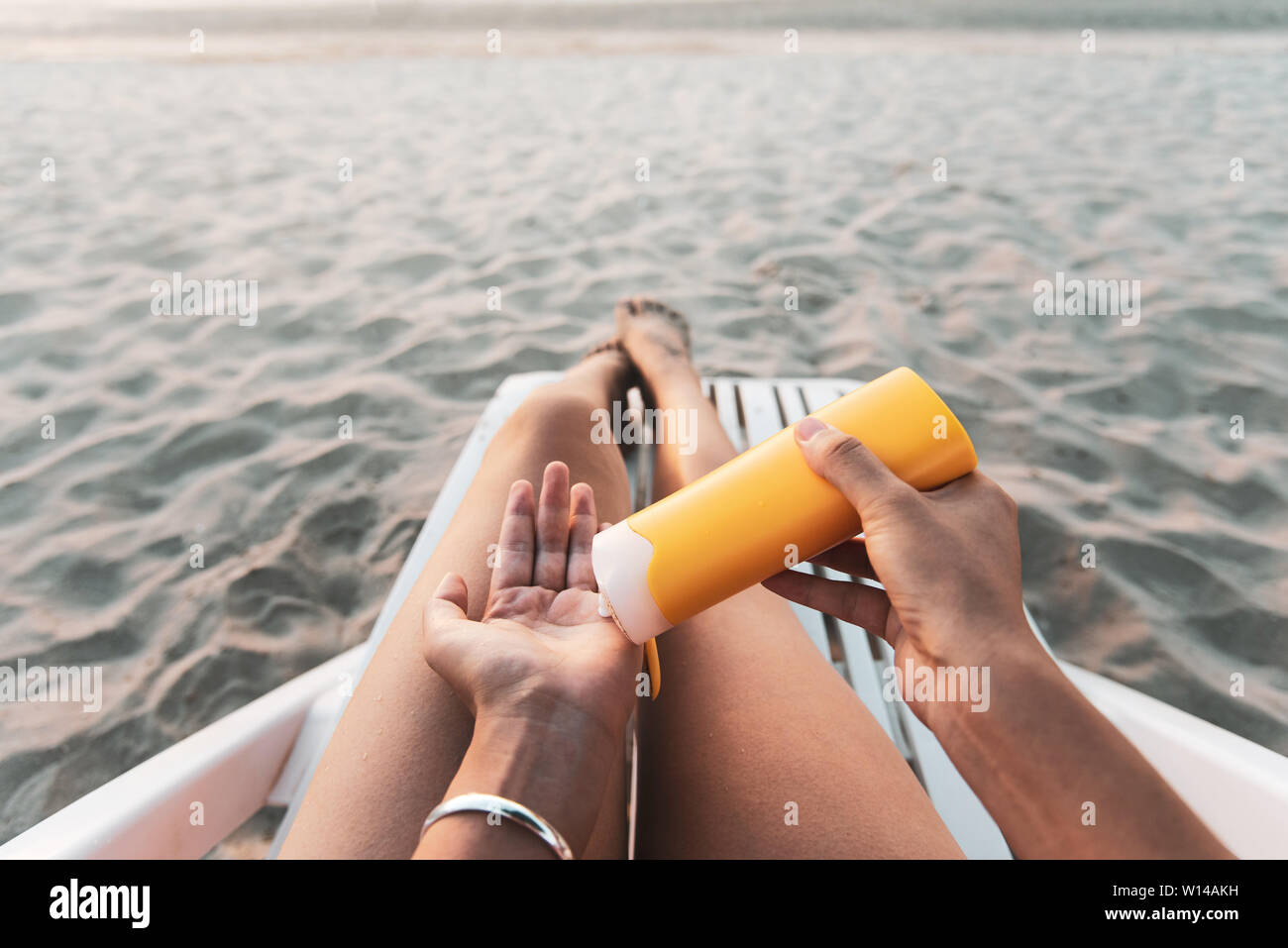 Putting on the sun lotion hi-res stock photography and images - Alamy