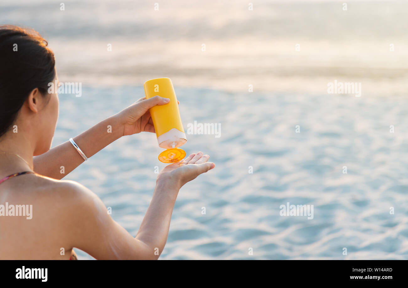 Woman using sun lotion on beach summer vacation Stock Photo - Alamy