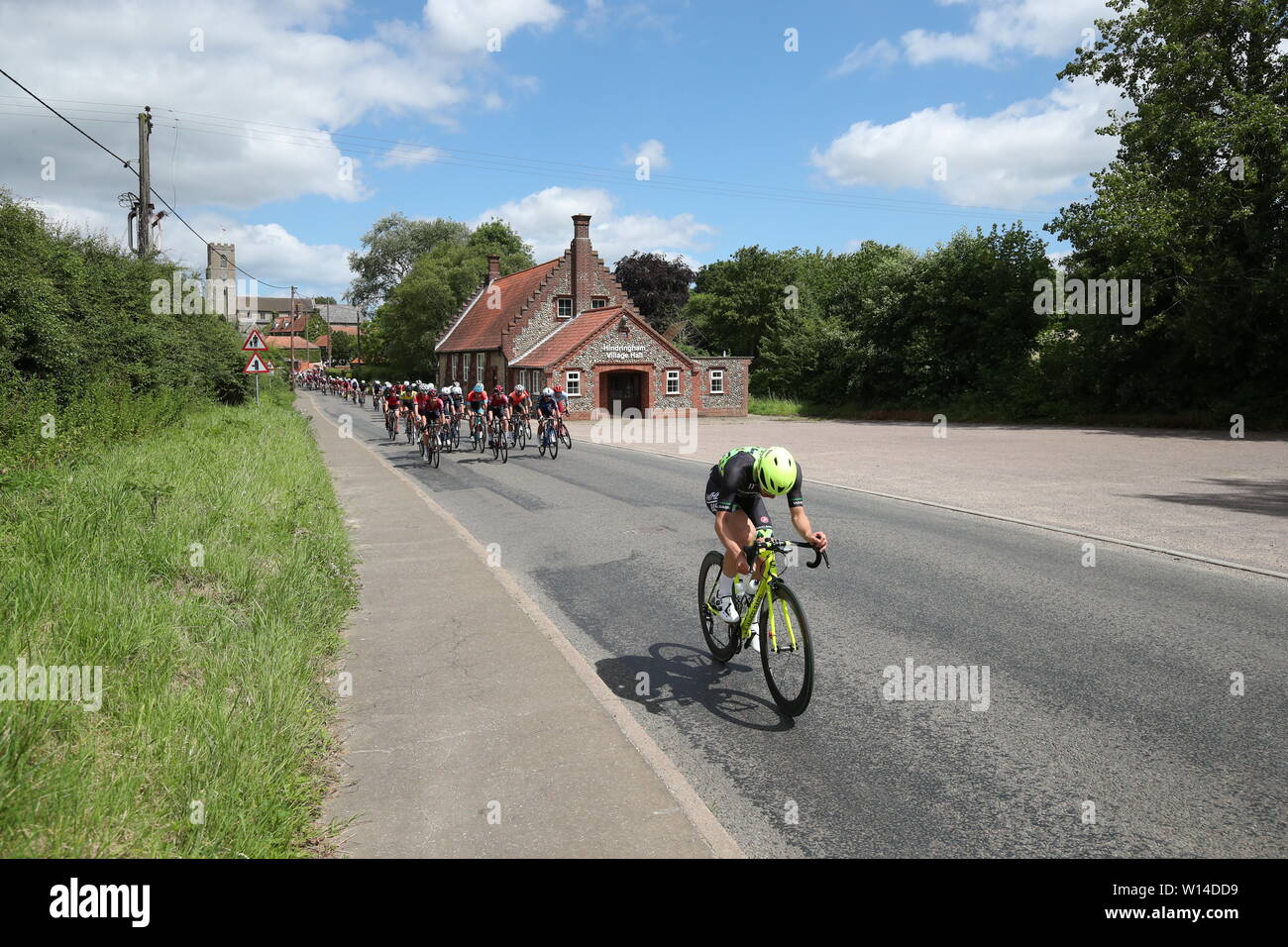 The Men's Elite Peloton passes through the village of Hindringham ...