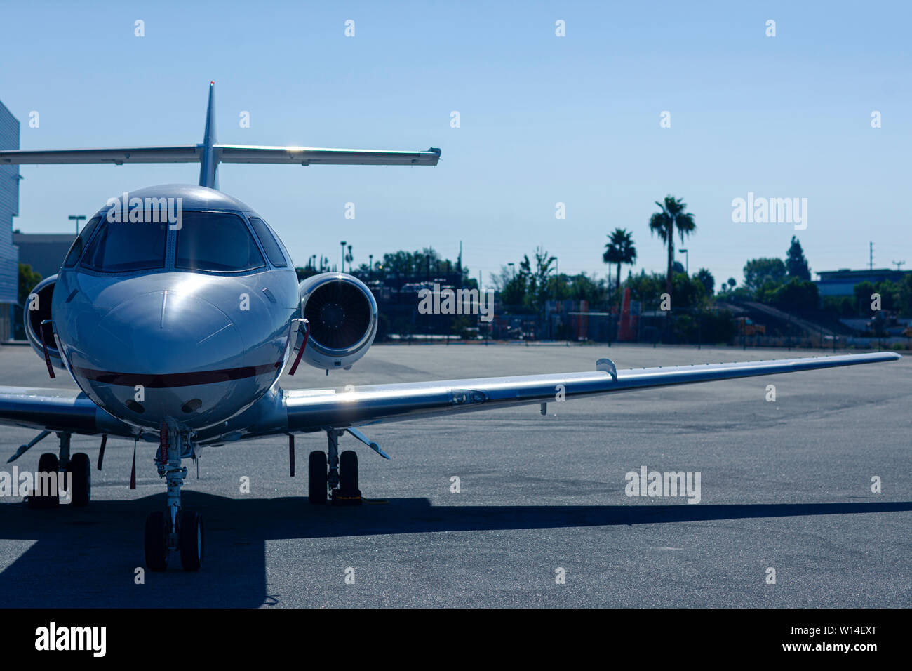 Luxury private jet is parked on an airfield at dusk Stock Photo - Alamy