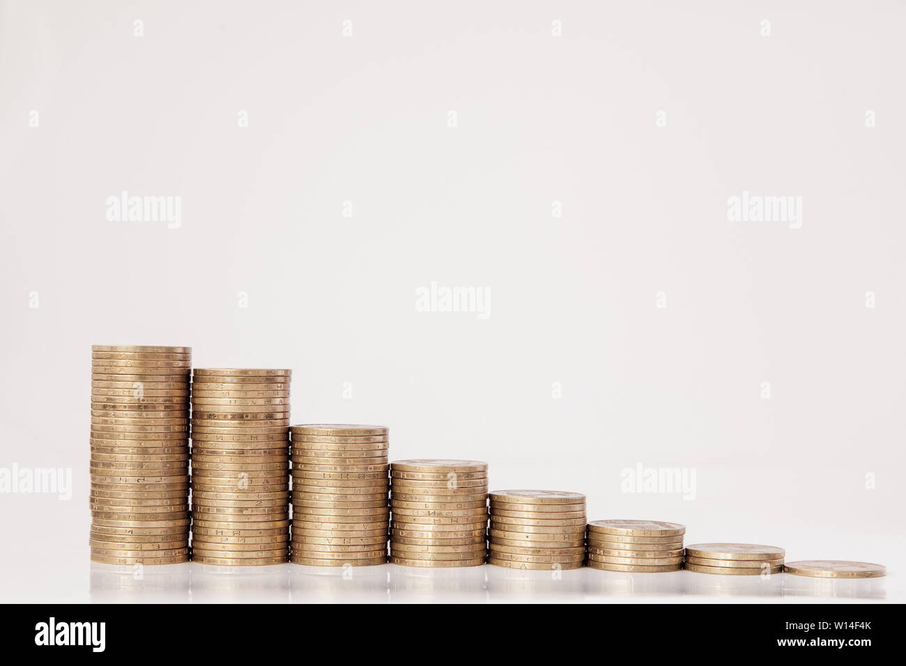 Coins in the form of a histogram on a white background. Concept of ...