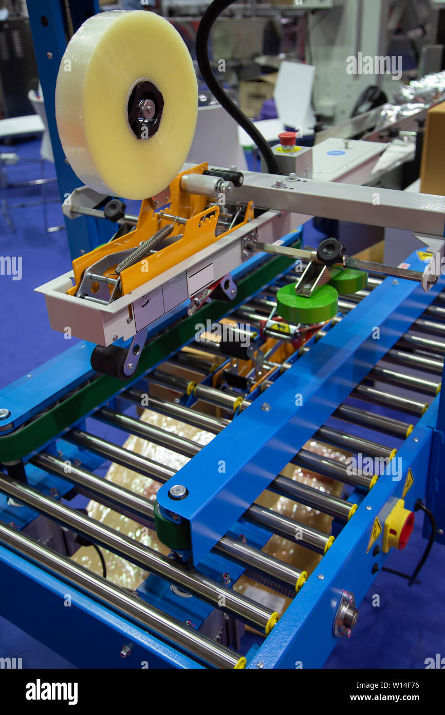 Semi automatic cardboard box tape sealing machine Stock Photo - Alamy