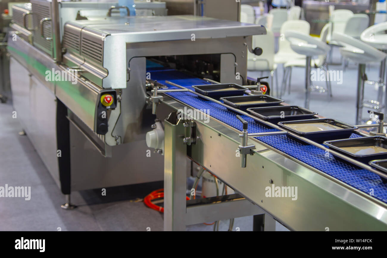 Linear tray food heat sealing and packaging machine Stock Photo - Alamy
