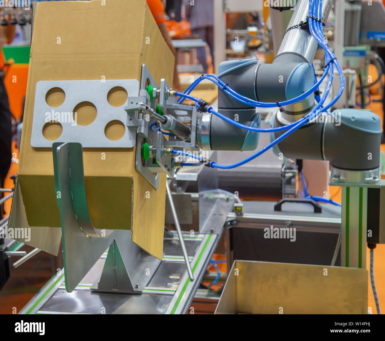 Robotic arm forming cardboard from flat cardboard magazine Stock Photo ...