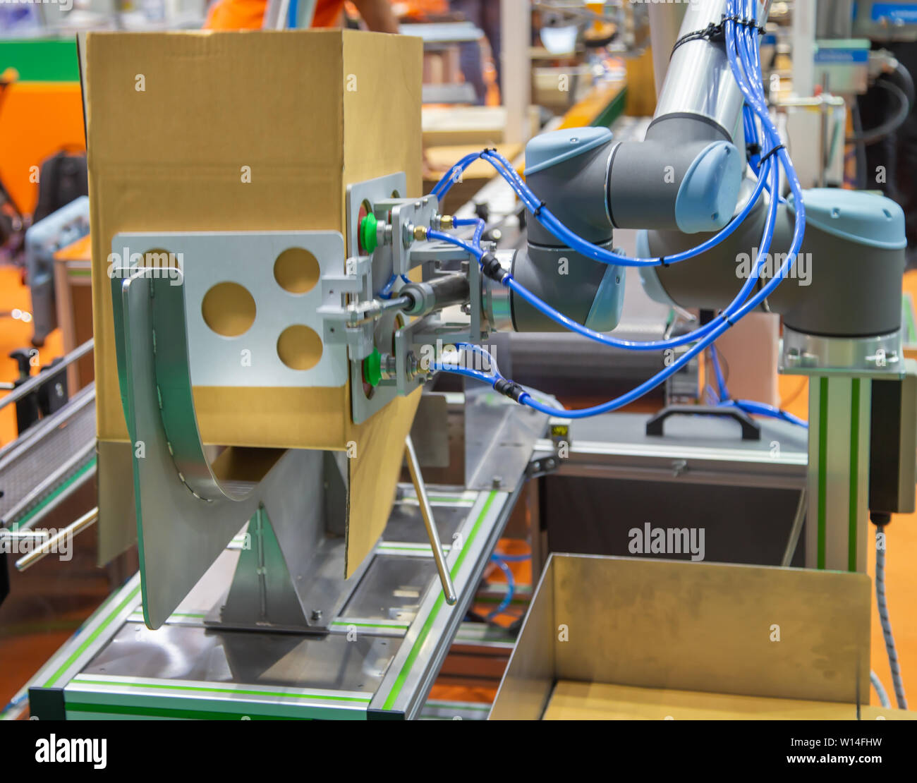 Robotic arm forming cardboard from flat cardboard magazine Stock Photo ...