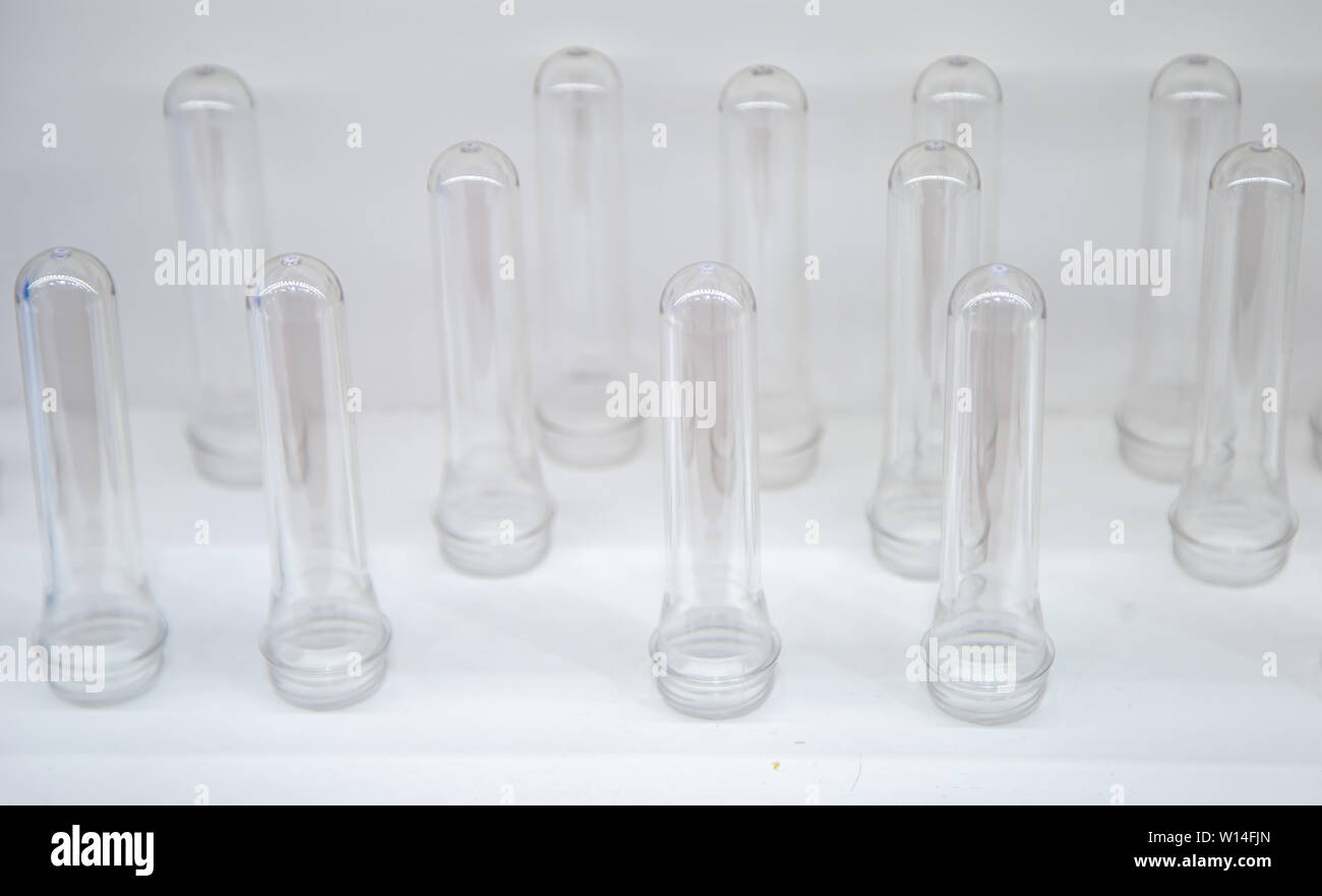 Raw material for plastic bottle blowing machine Stock Photo - Alamy