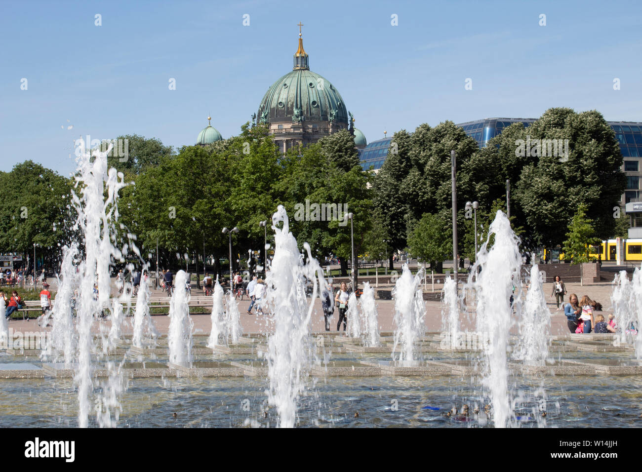 Fountains on Alexanderplatz, with the green dome of Berlin Cathedral on ...