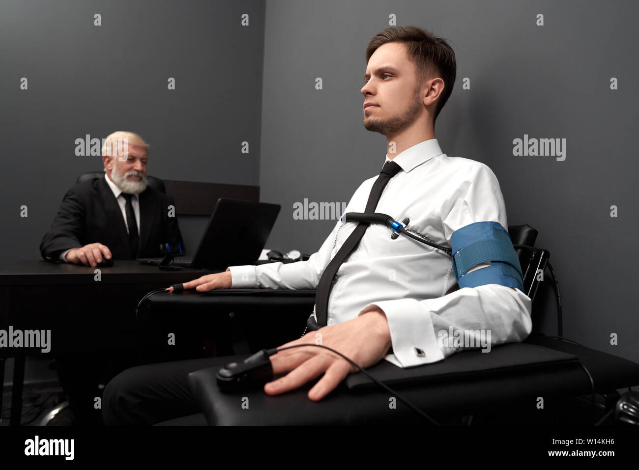 View from side of honest man sitting with indicators on fingers and ...