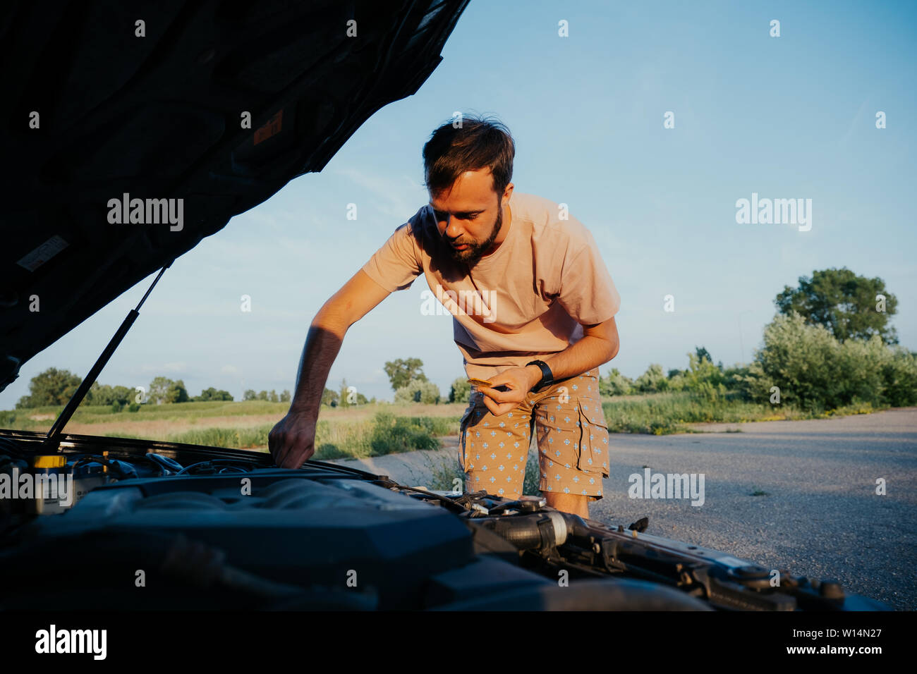 Mechanic lifting hood of car hi-res stock photography and images - Alamy