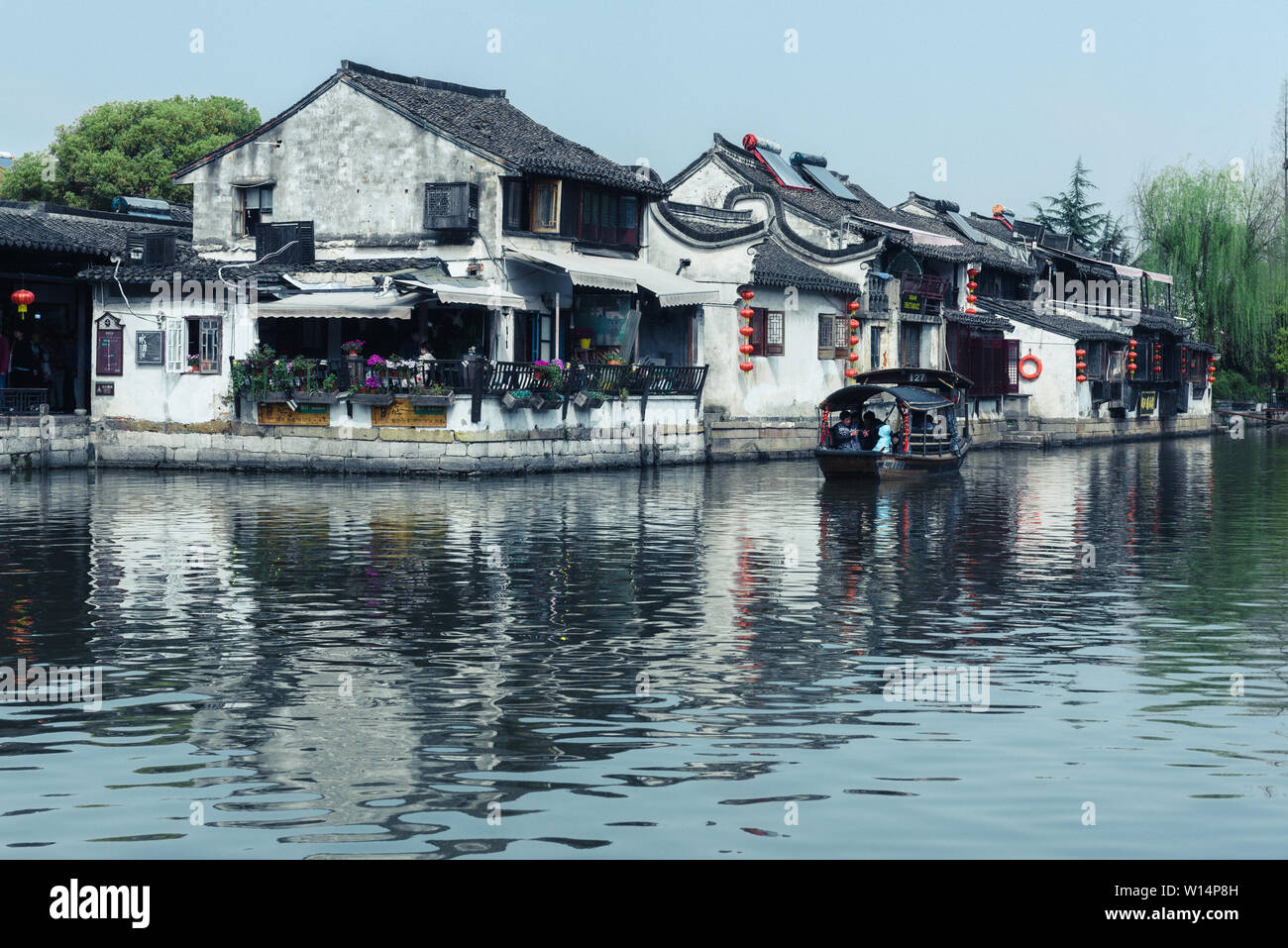 Tourist boats on the water canals of Xitang Town in Zhejiang Province ...