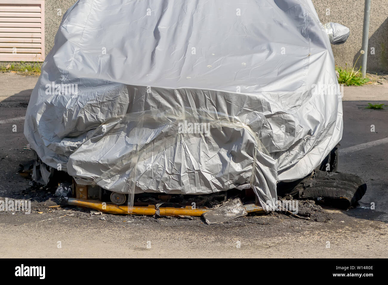 Car damaged by fire. Partially burnt cars covered with a gray film on a ...