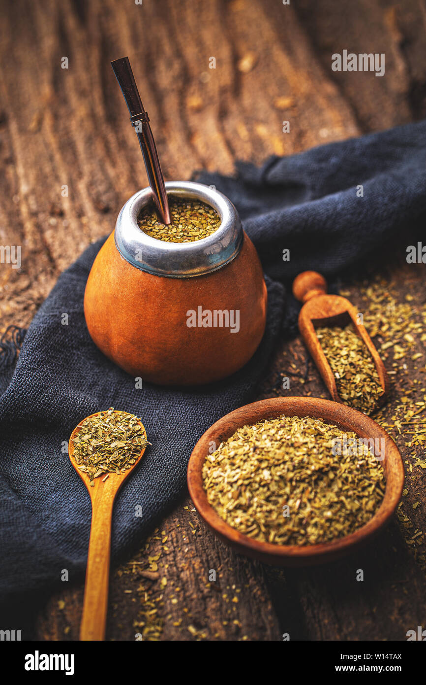 Yerba Mate In Calabash With Bombilla And Dry Herb In Wooden Bowl On