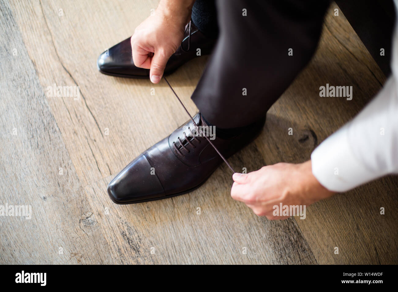 Elegant man tying shoe hi-res stock photography and images - Alamy