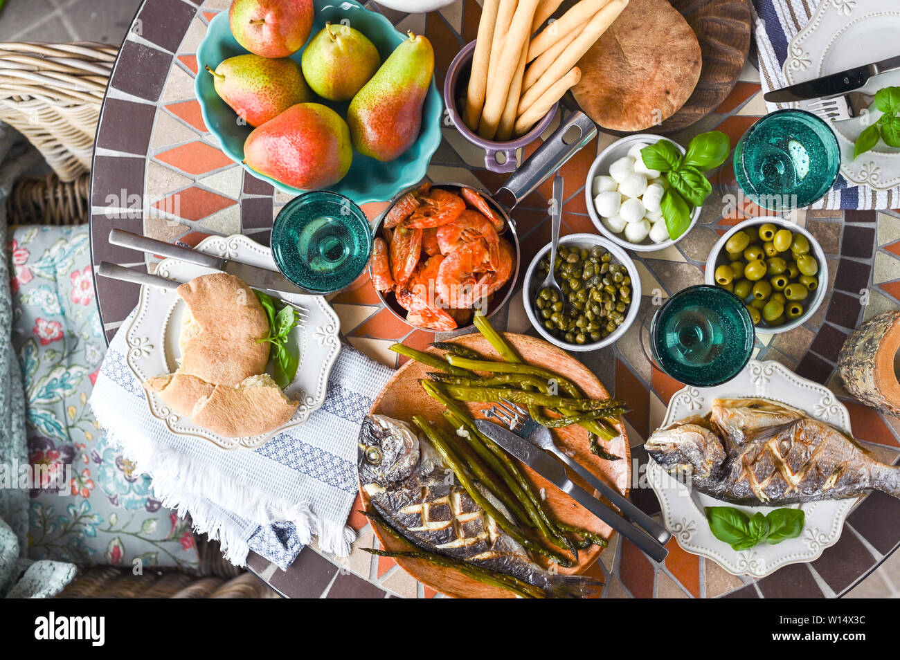 Dining table with different food and snacks. Seafood and vegetable ...
