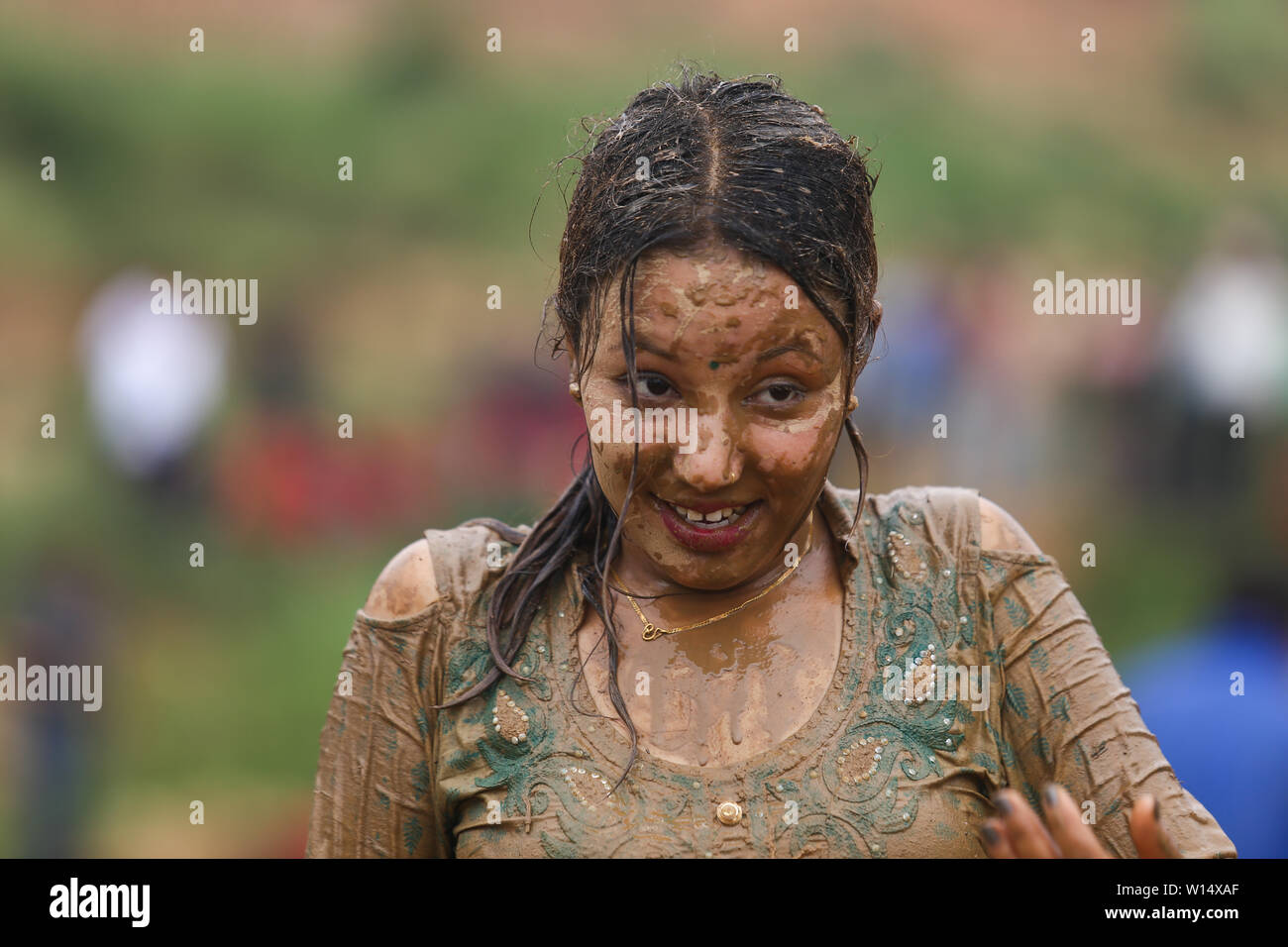 A woman covered in mud during a Festival.Farmers celebrate National ...