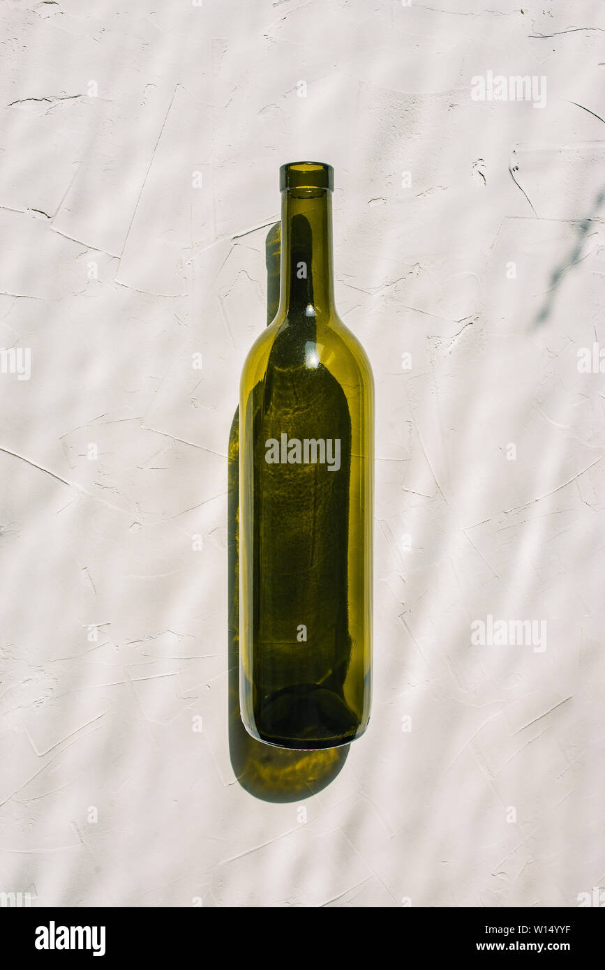 Empty bottle against white background. Hard shadows and reflection from ...