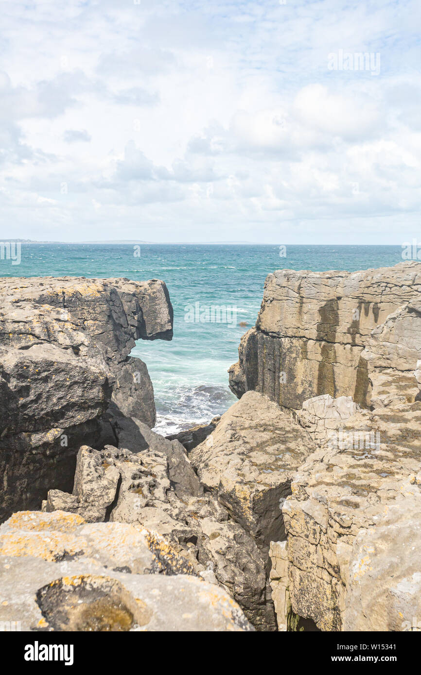 View of the limestone rock of sea cliff with the ocean in the ...