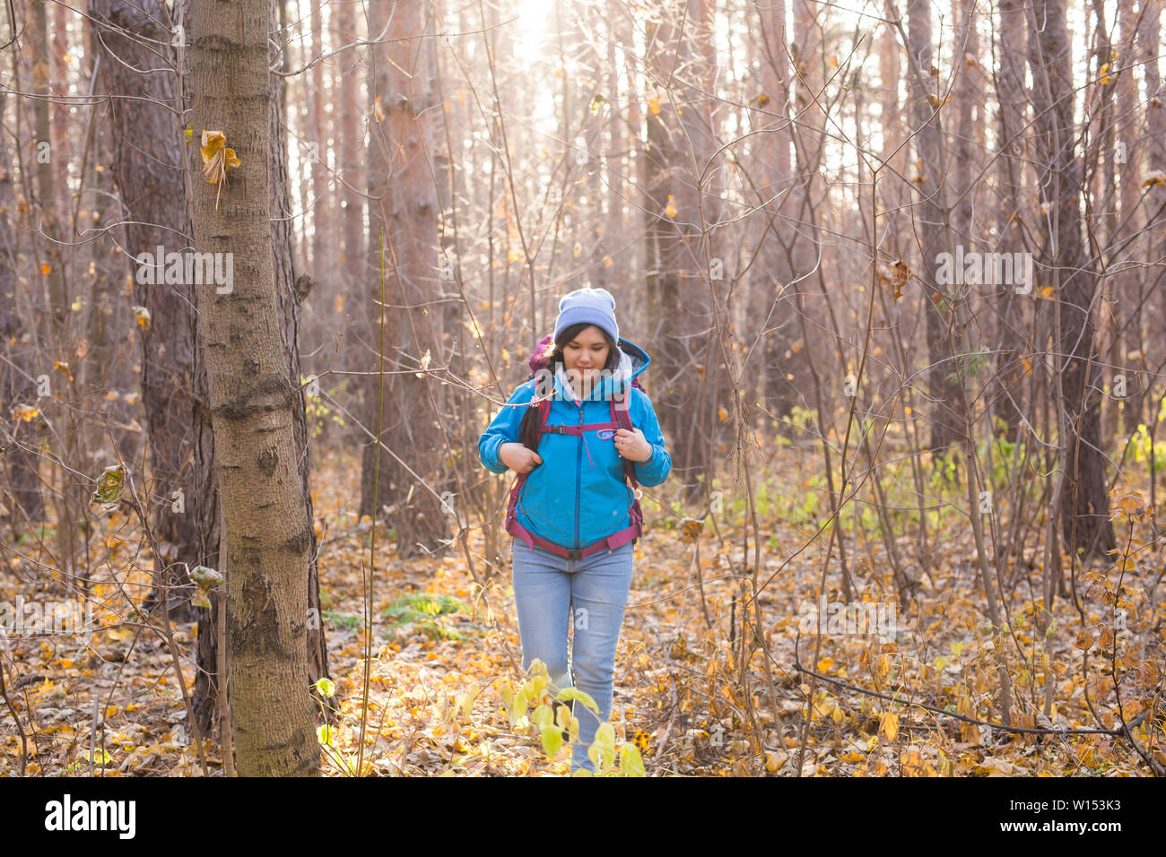 People, hike and nature concept - Female tourist walking in the autumn ...