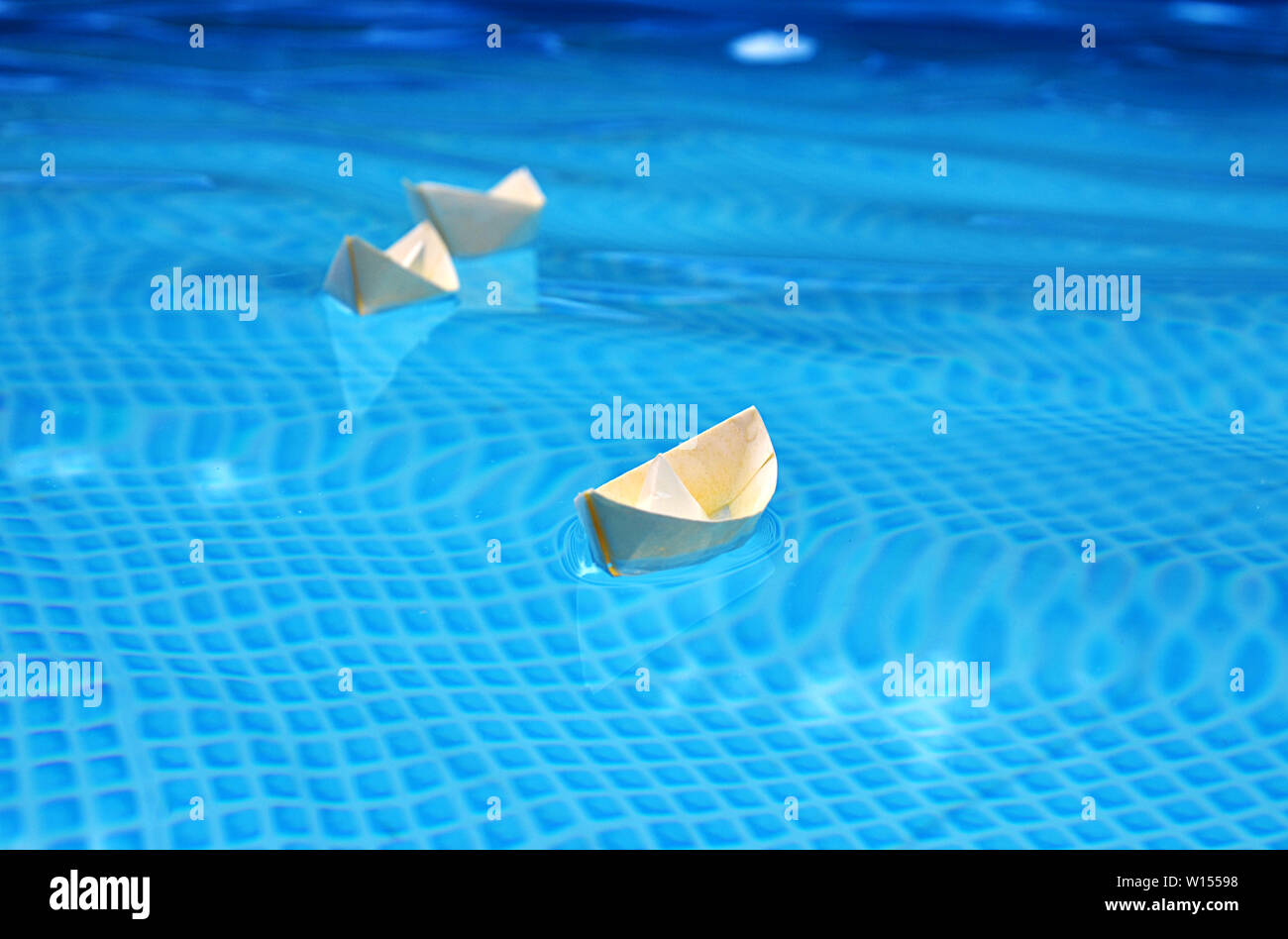 Three little ships of paper are swimming in the blue water Stock Photo ...