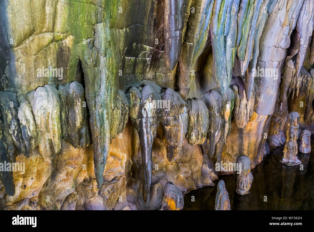 stalagmite stones hanging on the ceiling of a drip cave, beautiful ...