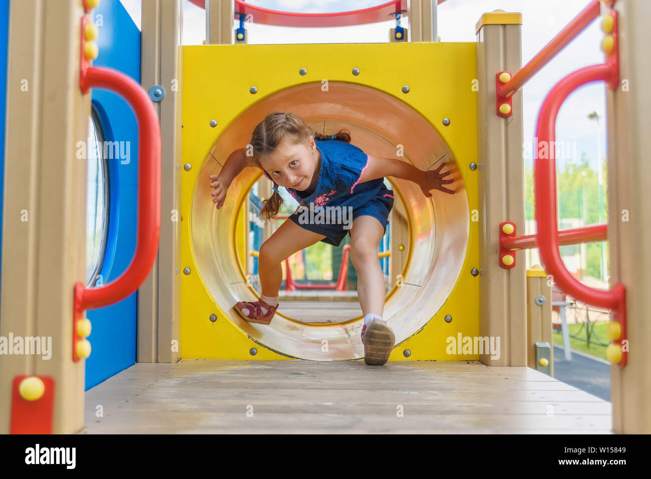 Active little girl on playground Stock Photo - Alamy
