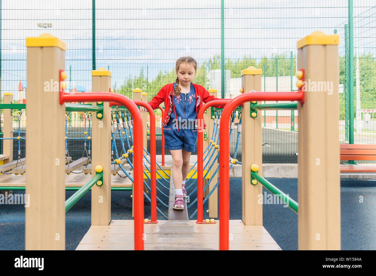 Active little girl on playground Stock Photo - Alamy