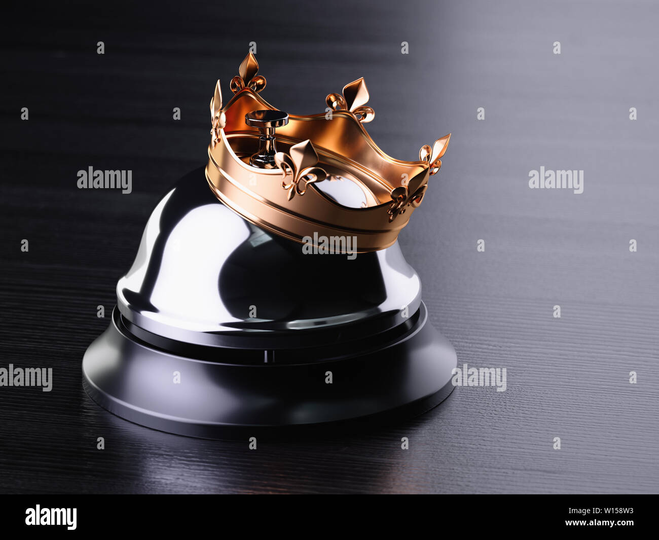 Reception bell with golden crown on black table with shallow depth of ...