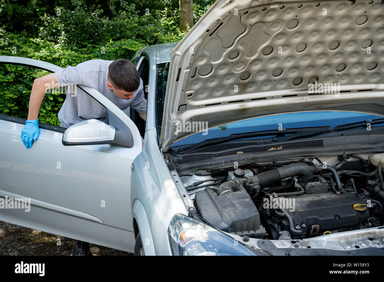 Teenage caucasian boy testing a newly repaired engine Stock Photo - Alamy