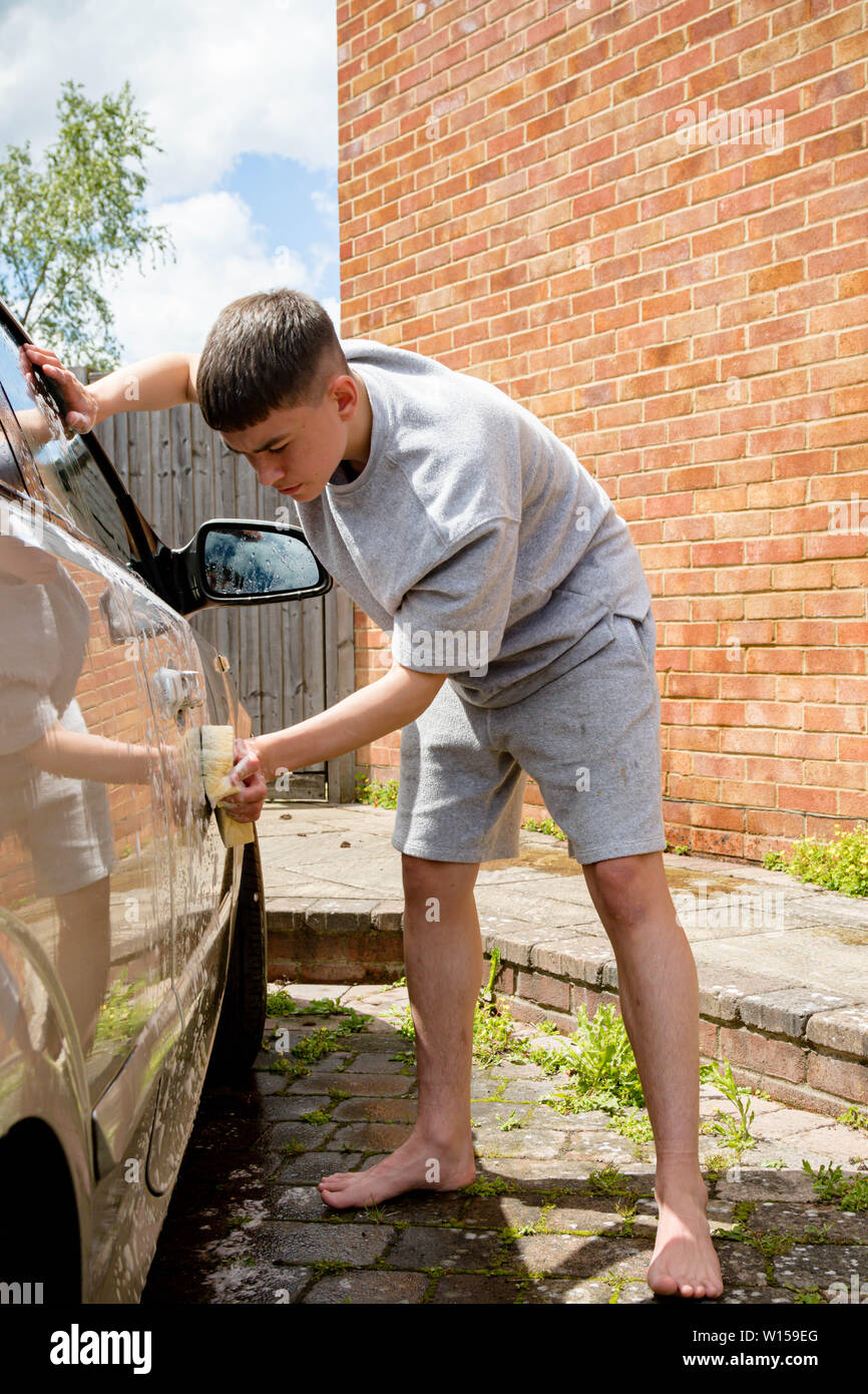 Teenage boy washing a car on a warm summer's day Stock Photo - Alamy