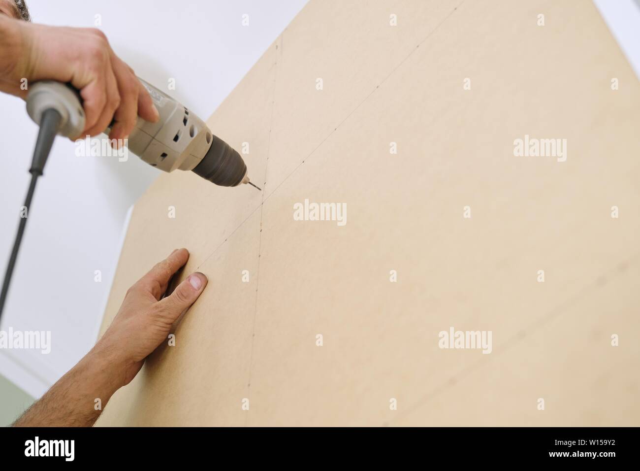 Installation of furniture. Closeup of workers hand with professional ...