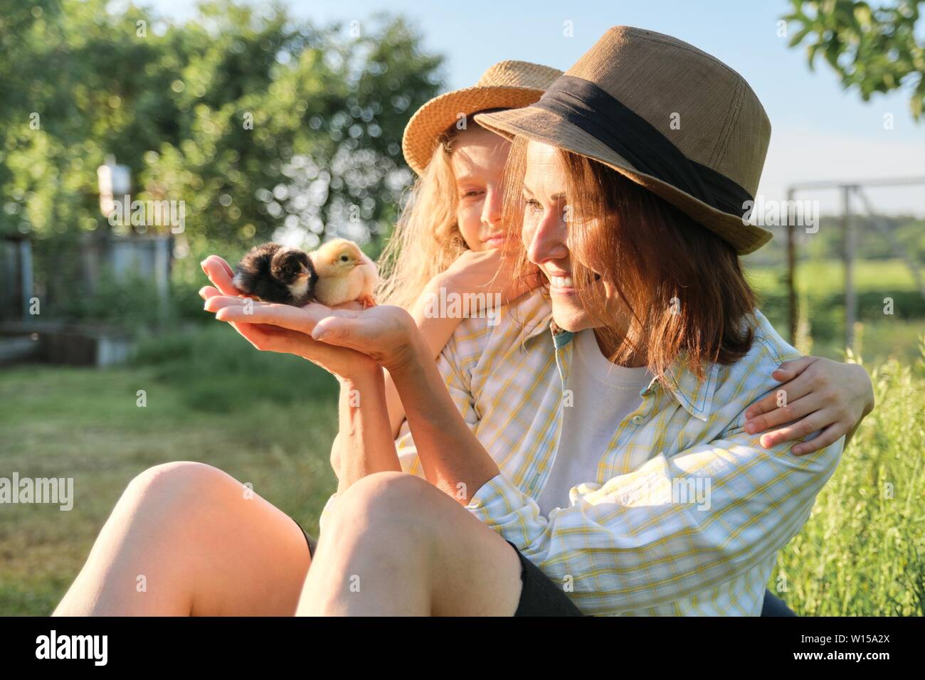 Country rustic style, happy mom and daughter together with newborn baby ...
