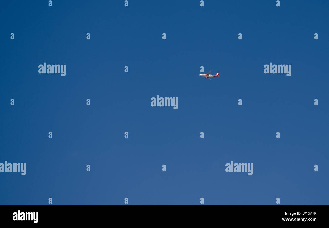 Malta, May, 2019: Distant Air Malta airplane flying across deep blue ...
