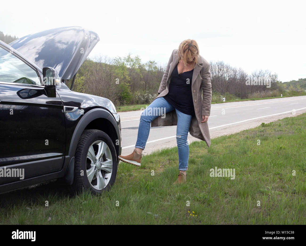 Accident and breakdowns with auto concept. Blonde woman and broken down ...