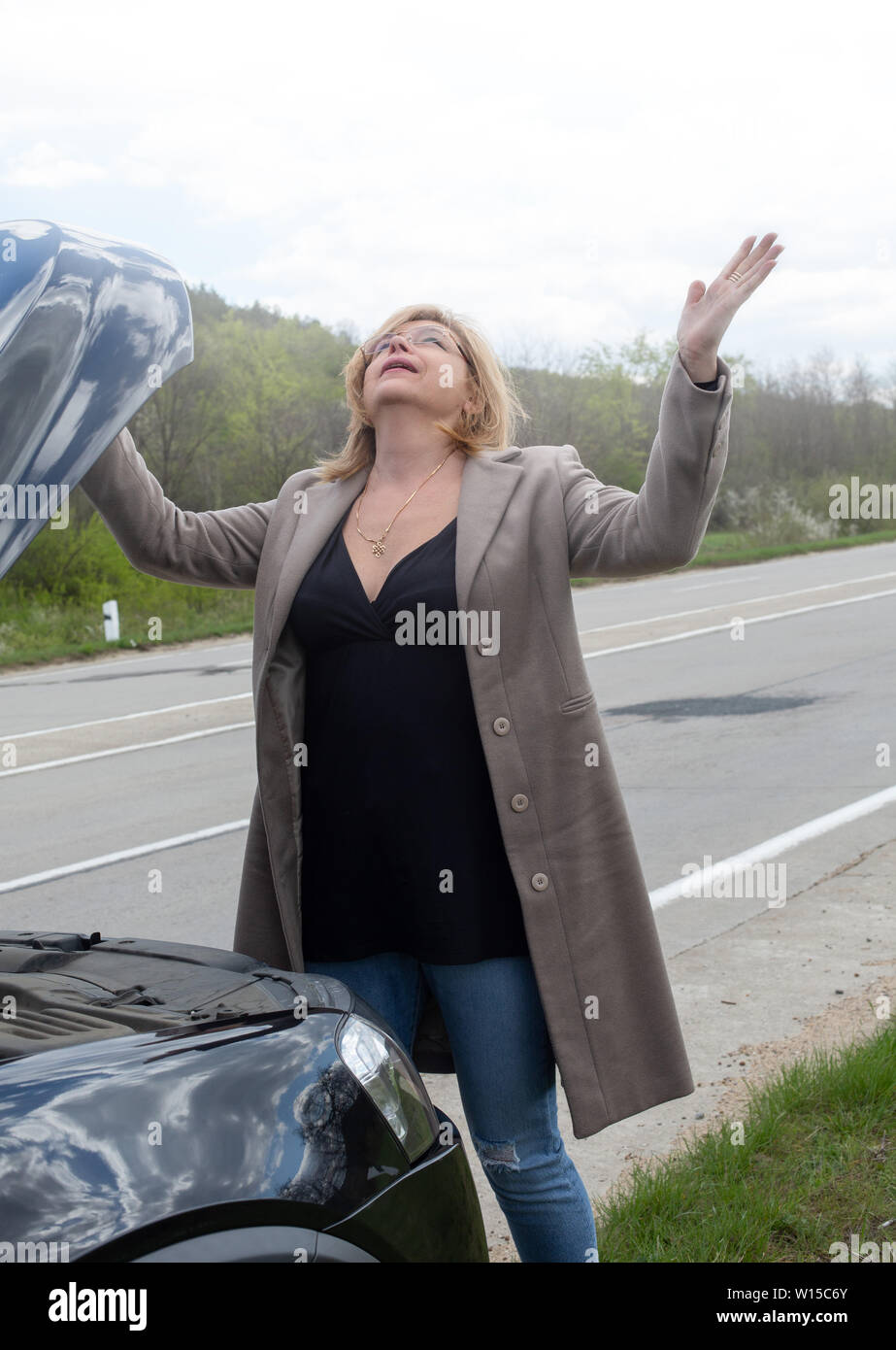 Accident and breakdowns with auto concept. Blonde woman and broken down ...