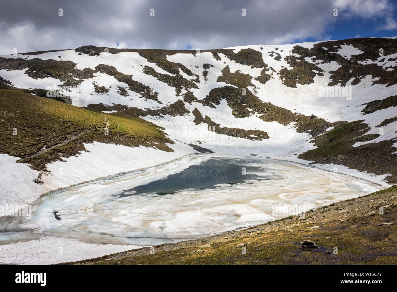 Dramatic view of The Tear lake, the highest of iconic seven Rila lakes ...
