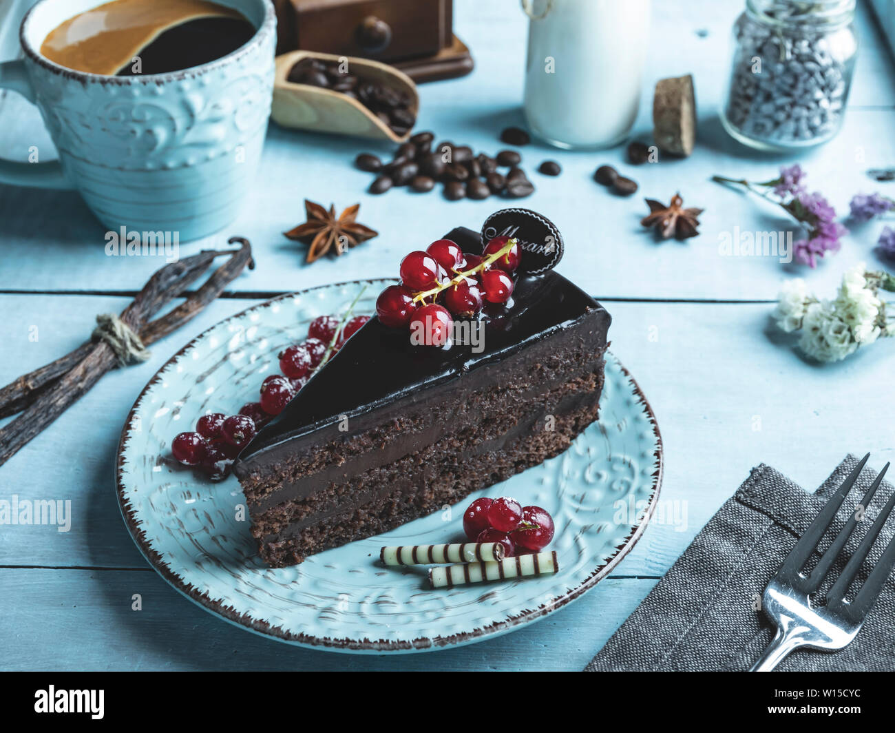 dark chocolate cake mozart , red currant on the table a cup of coffee ...