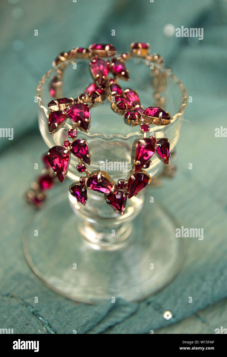 Ruby necklace draped over a glass hi-res stock photography and images ...