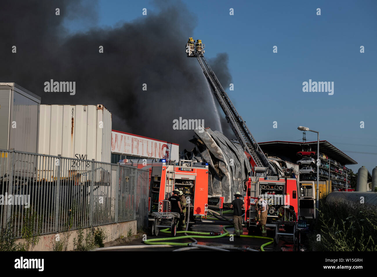 Berlin, Germany. 30th June, 2019. Fire brigade fights a fire next to a ...