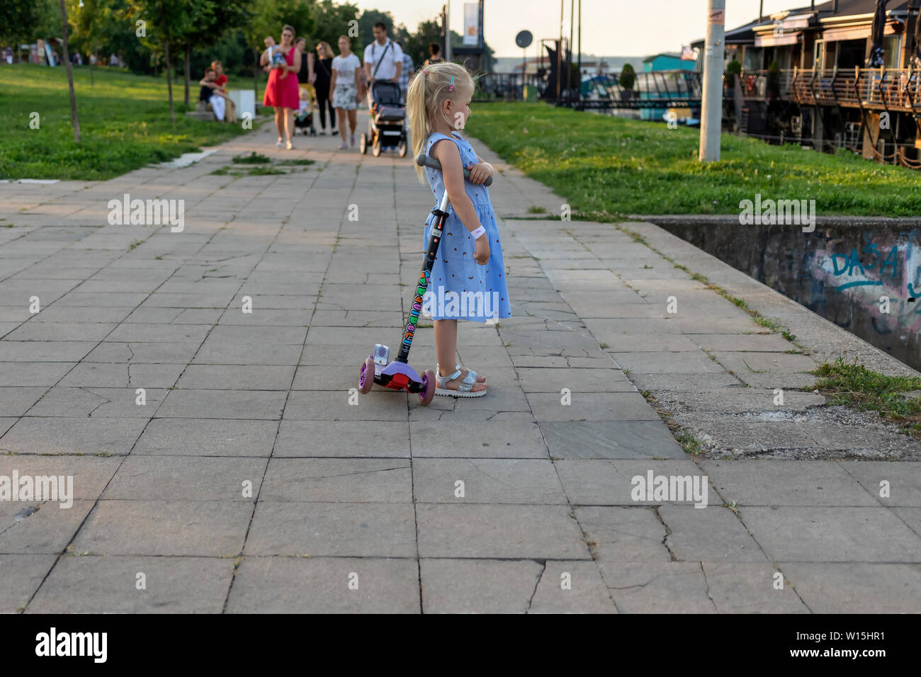 Belgrade, Serbia, June 27th 2019: Girl with a kick scooter standing and ...