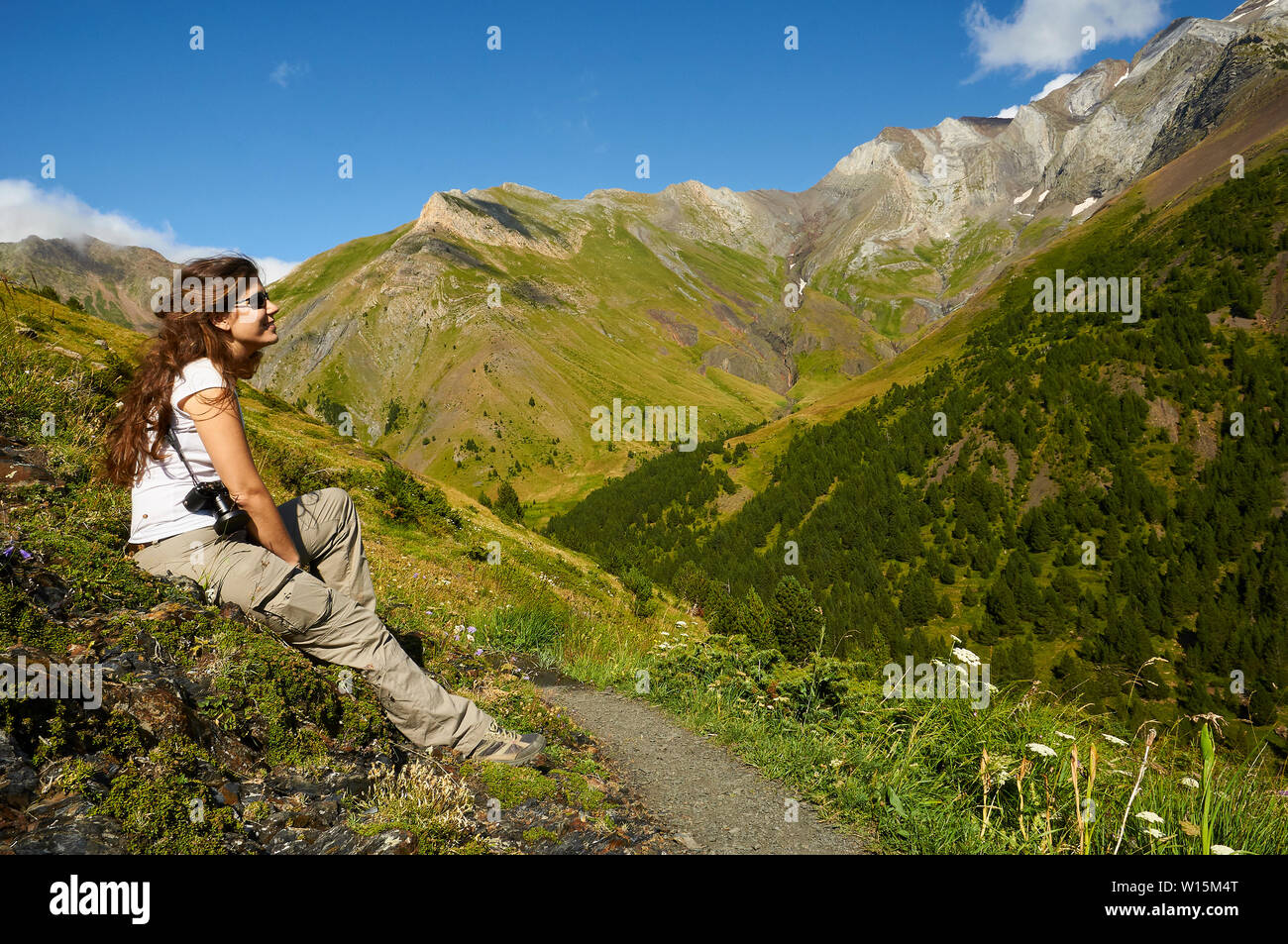 Female hiker resting in Transpirenaica GR-11 footpath with Posets ...