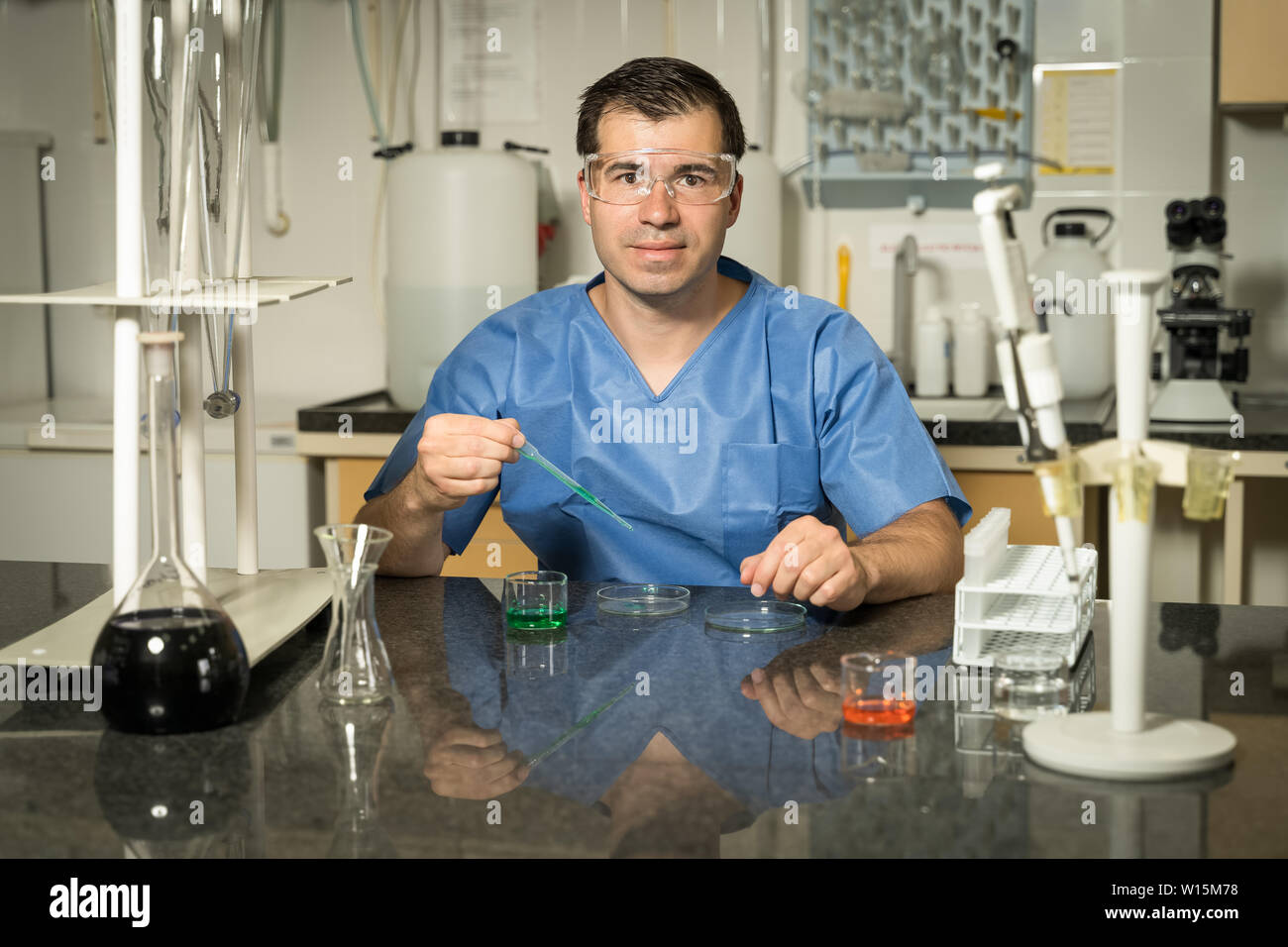 Middle age, Caucasian white, male laboratory technician in blue scrubs ...
