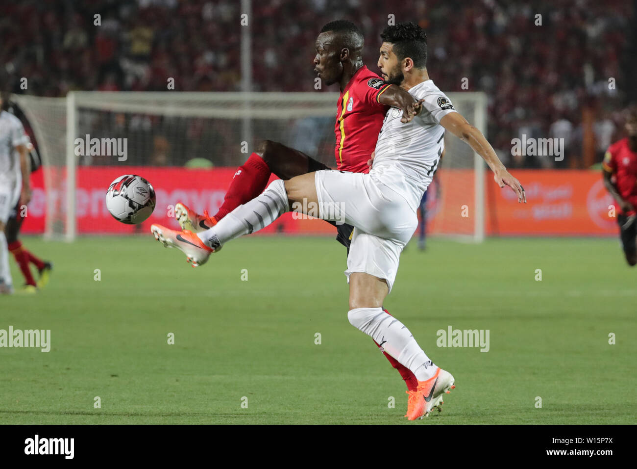 Cairo, Egypt. 30th June, 2019. Egypt's Ayman Ashraf (R) and Uganda's ...
