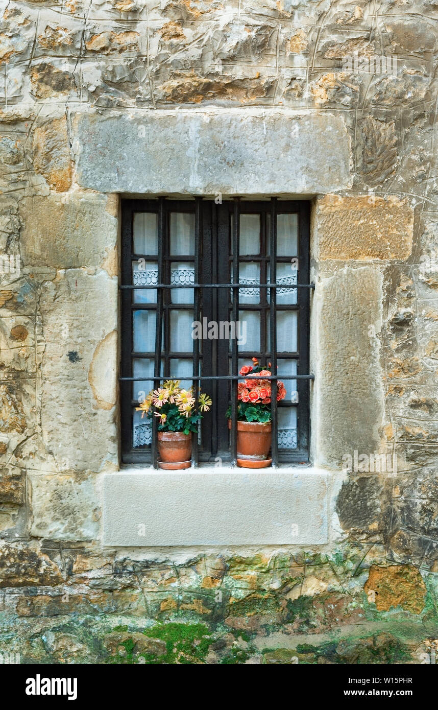 stone wall and window with bars and flowers Stock Photo - Alamy