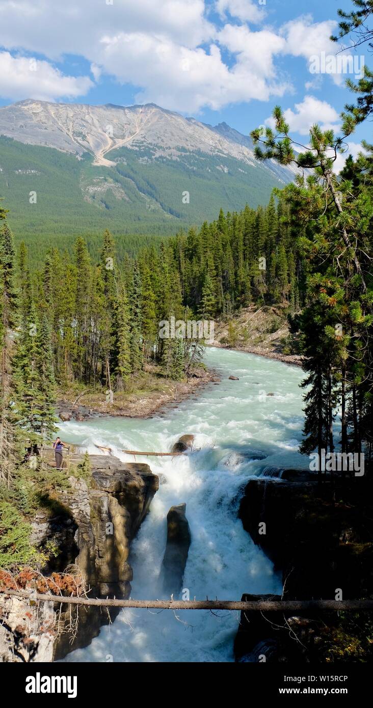 clear water river in front of mountain range Stock Photo - Alamy
