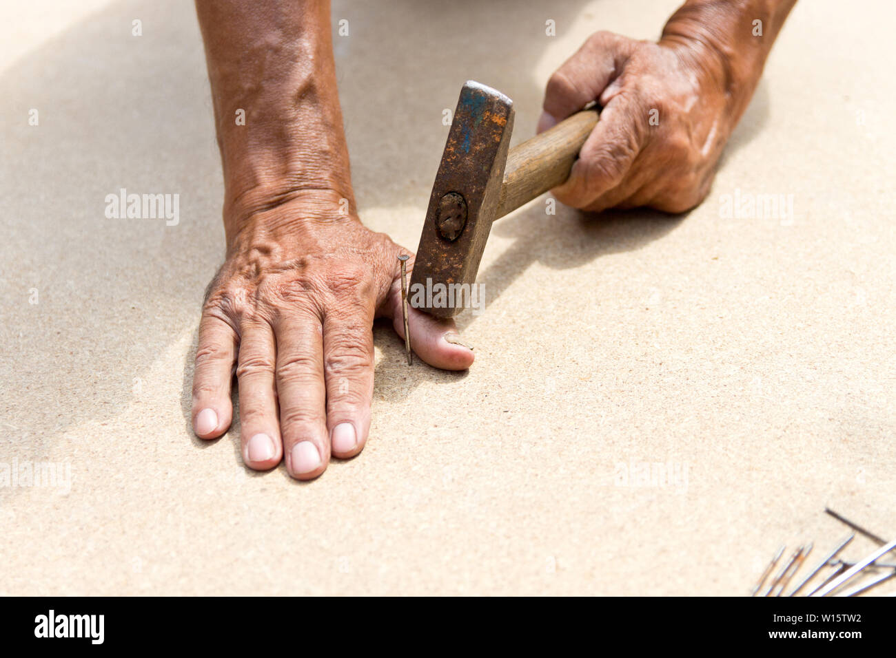 The man hit his finger with a hammer. Professional carpentry, woodwork ...