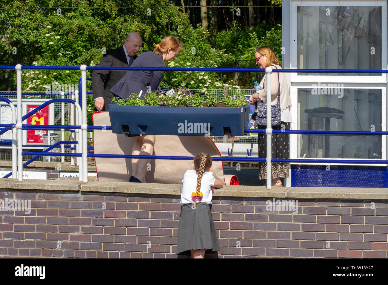 The red carpet is placed down, watched by a little girl. HM The Queen ...