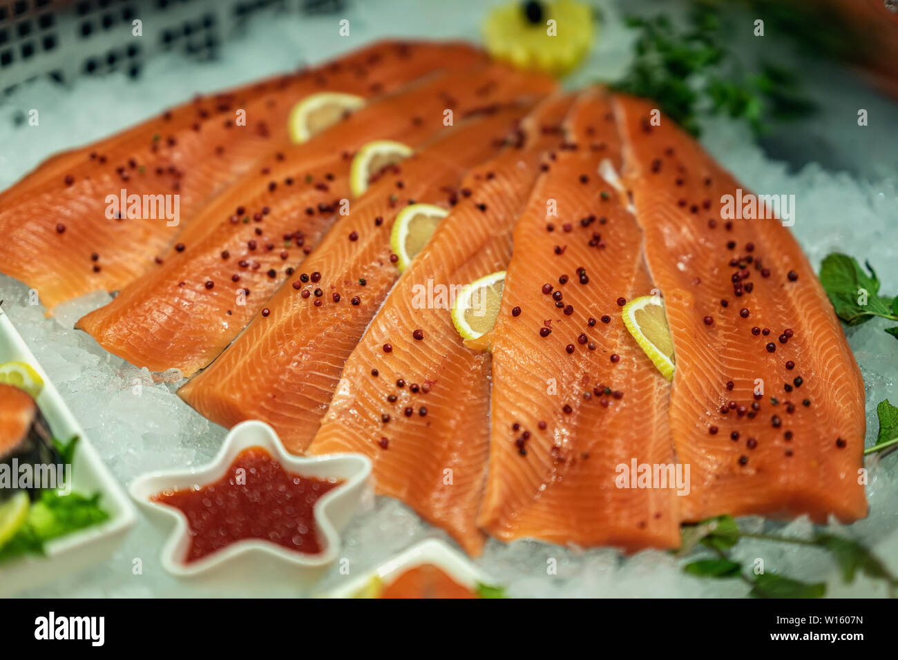 Fillet of salmon to portions on ice in farmers bazaar. Sale of seafood ...
