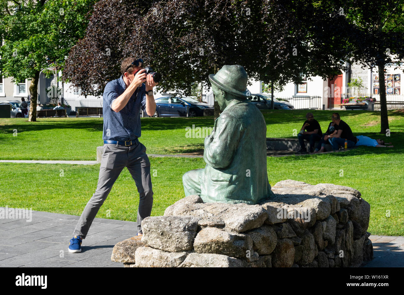 A photographer taking pictures of the Padraic O Conaire statue in Eyre ...
