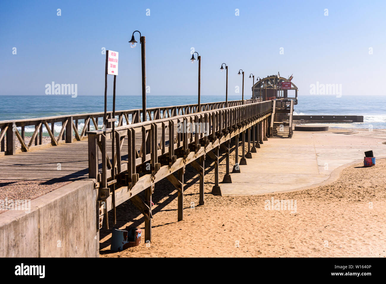 Wooden jetty reaching out to the Atlantic Ocean, Langstrand, Namibia ...