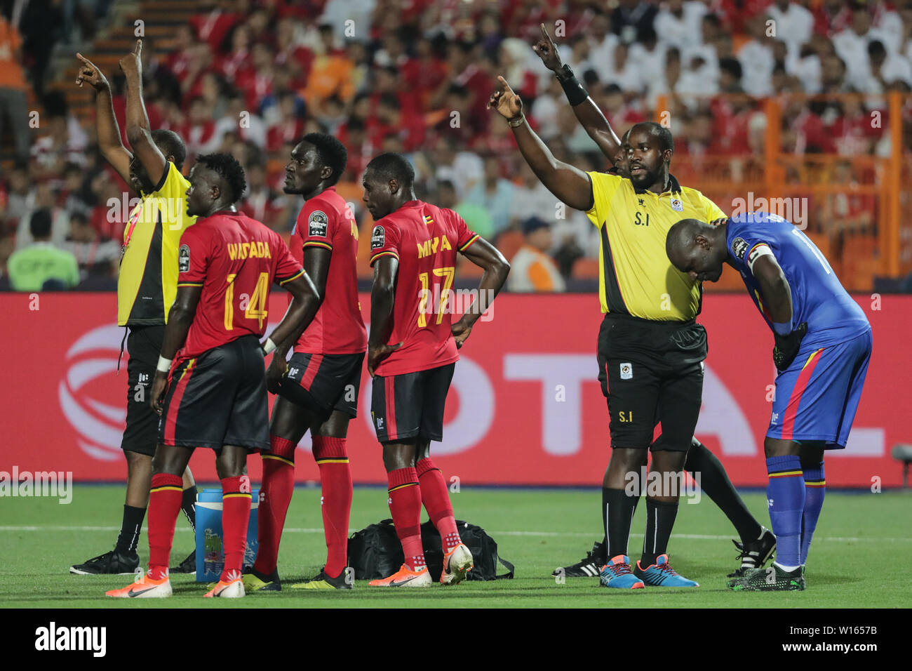 Cairo, Egypt. 30th June, 2019. Uganda players and medics react after ...